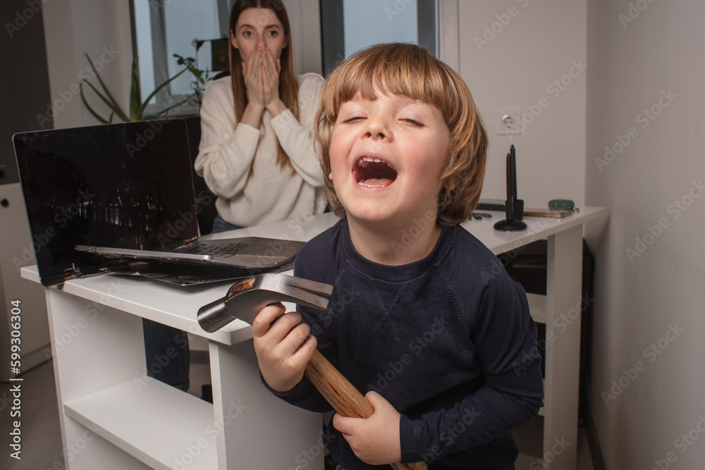 Happy child smashes mom's work laptop to spend more time together. The ...