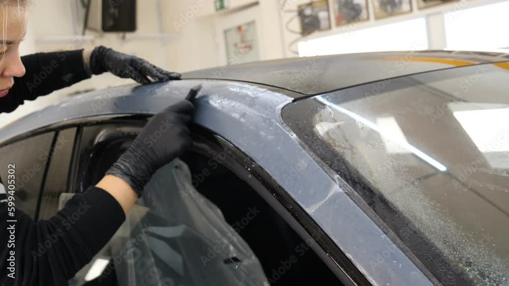 Close up to PPF installation process on a front headlight and hood. PPF ...