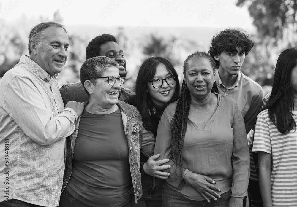 Group of multi generational people having fun together at city park ...