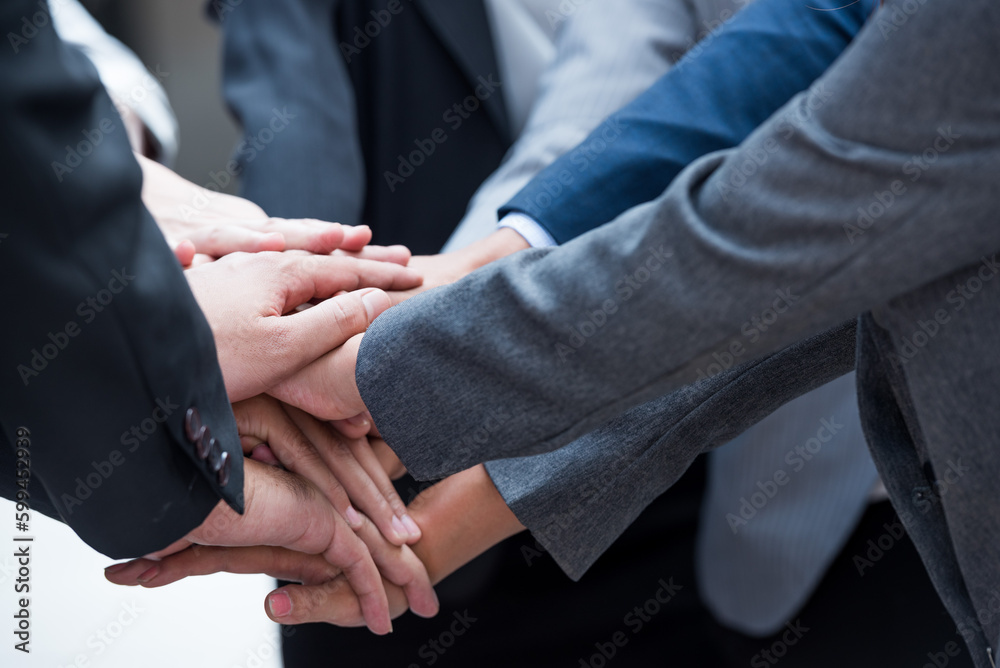 business people putting join hands together. Unity and teamwork show by Stack mix of hands with ...