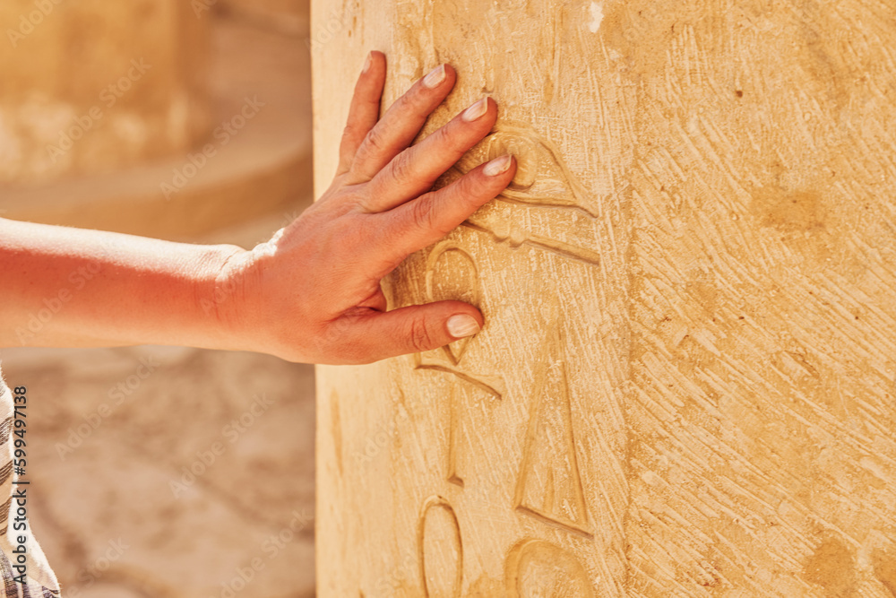 Image of hand touching Egyptian hieroglyphs in Mortuary Temple of ...