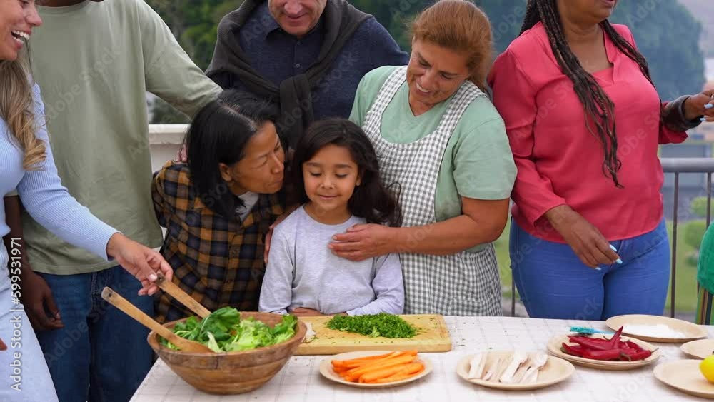 Happy multiracial people preparing dinner together at home rooftop ...