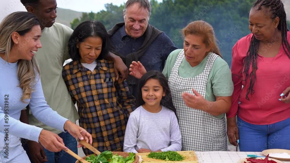 Happy multiracial people preparing dinner together at home rooftop ...