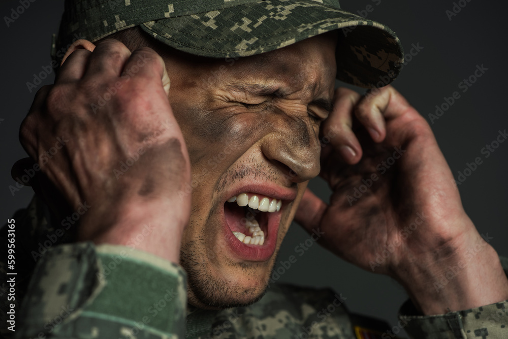 military man with dirt on face screaming while suffering from post ...