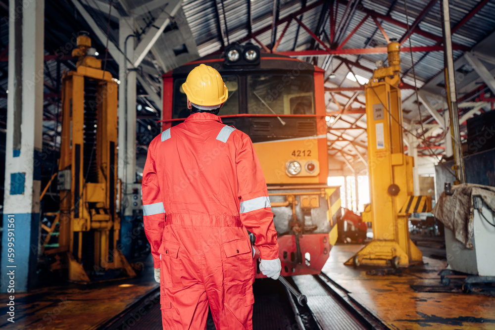 Engineer railway wearing safety uniform and helmet under checking under ...
