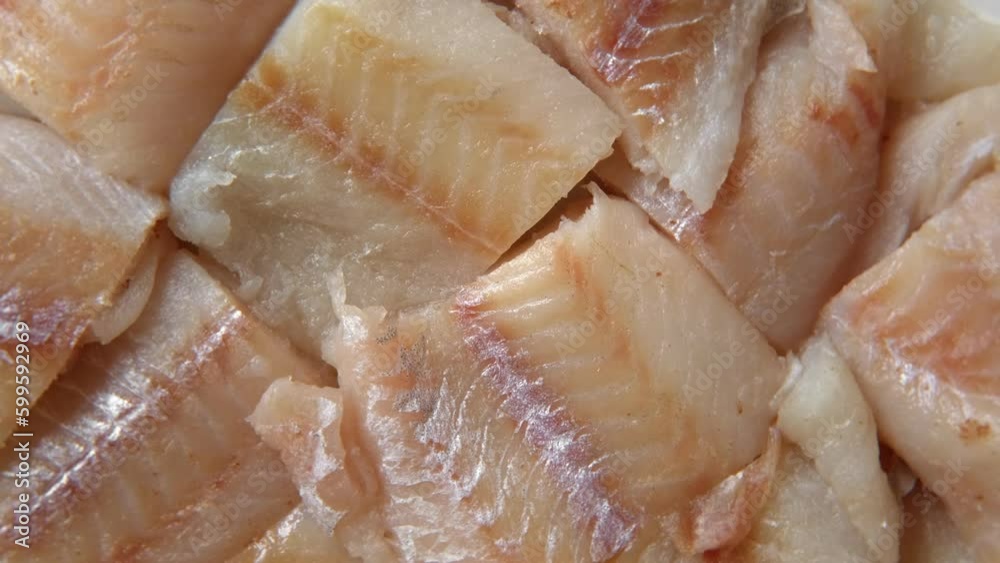 Raw fish fillet is spinning. Top view. Slices of fresh whitefish. Full ...