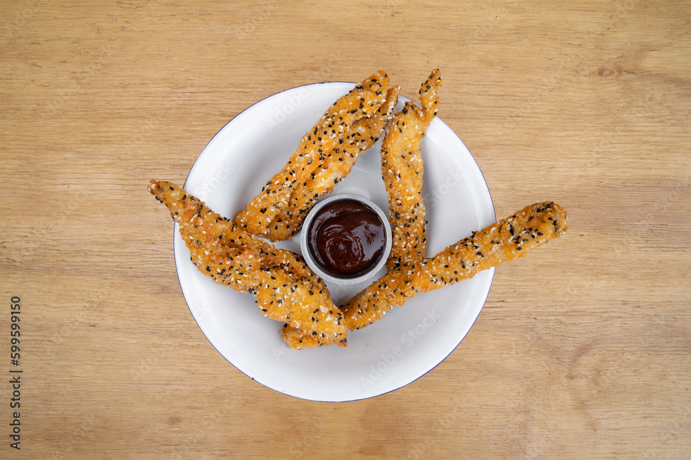 Rustic American food. Top closeup view of fried chicken sticks breaded ...
