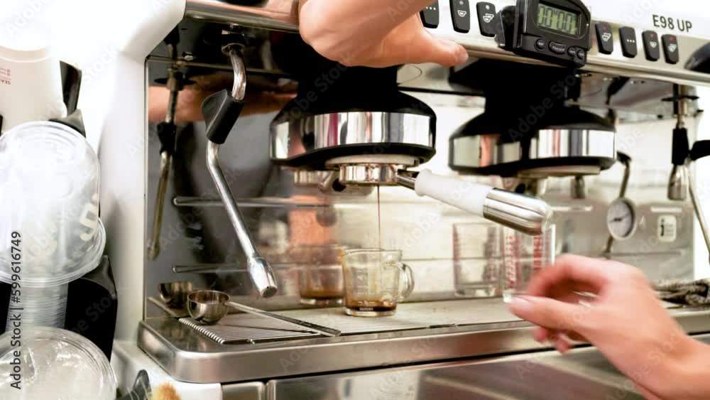Hot coffee being expertly prepared by a professional machine, with ...