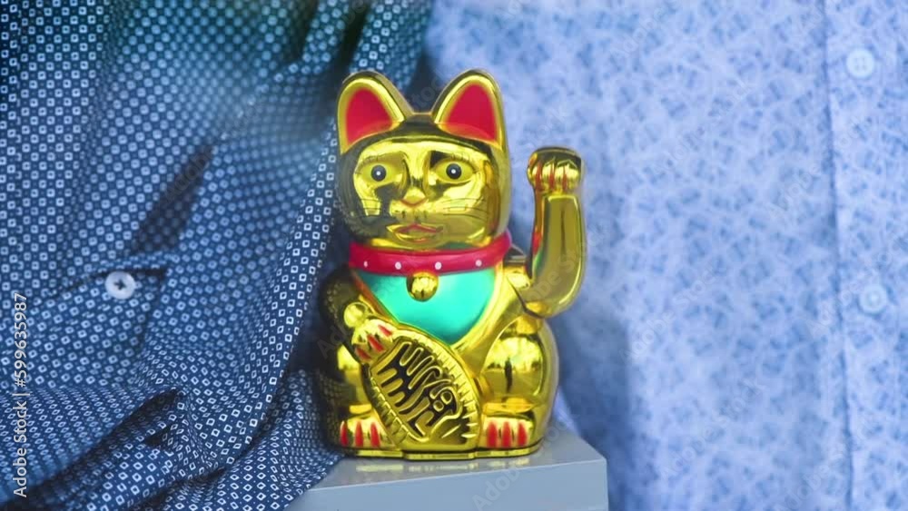 Chinese waving cat, also known as the Maneki-Neko, adorning the ...