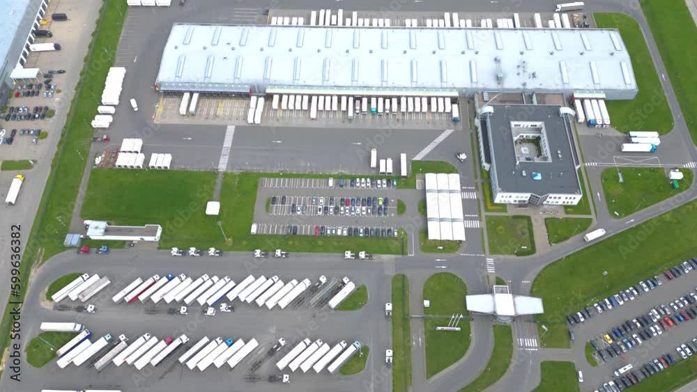 Time lapse Aerial shot of industrial warehouse. Loading hub and many ...