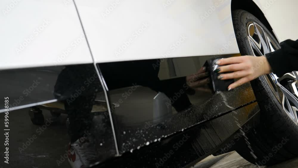 Close up to PPF installation process on a front headlight and hood. PPF ...