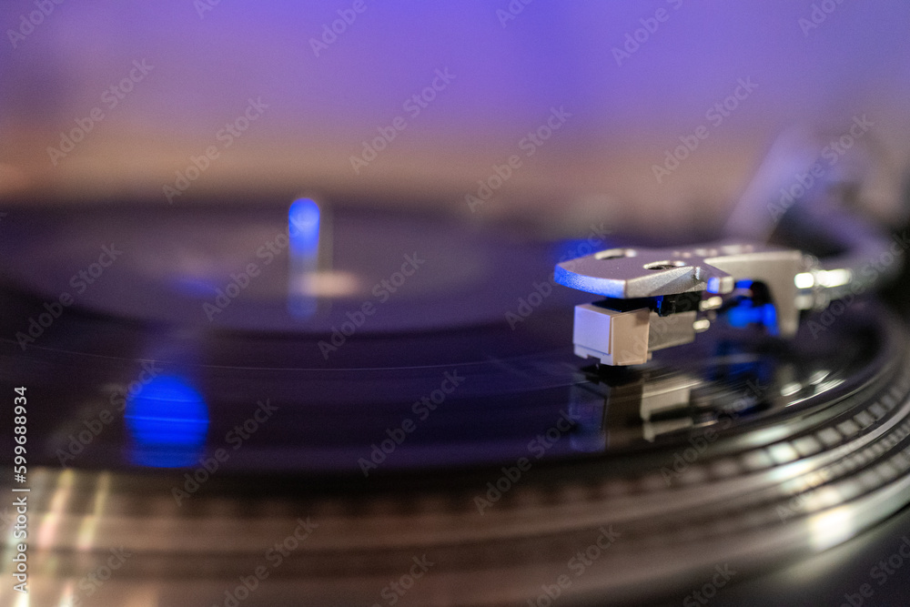 Turntable record player with needle on the record spinning fast. Motion ...