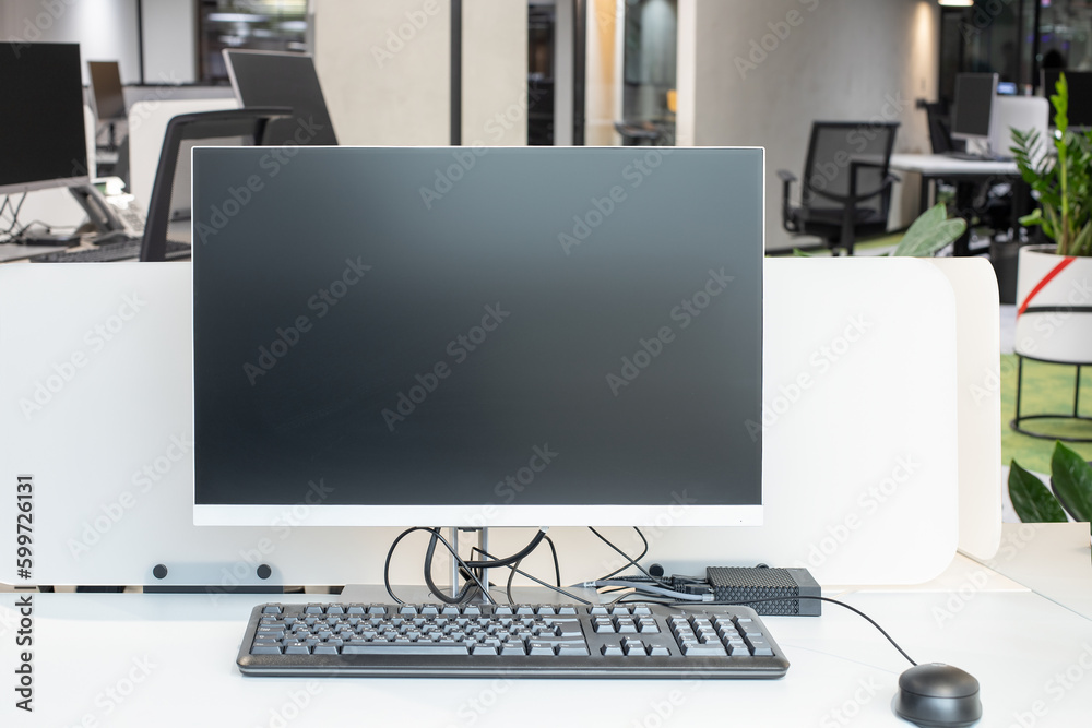Desktop computer with a black LCD monitor on a white office desk, next ...