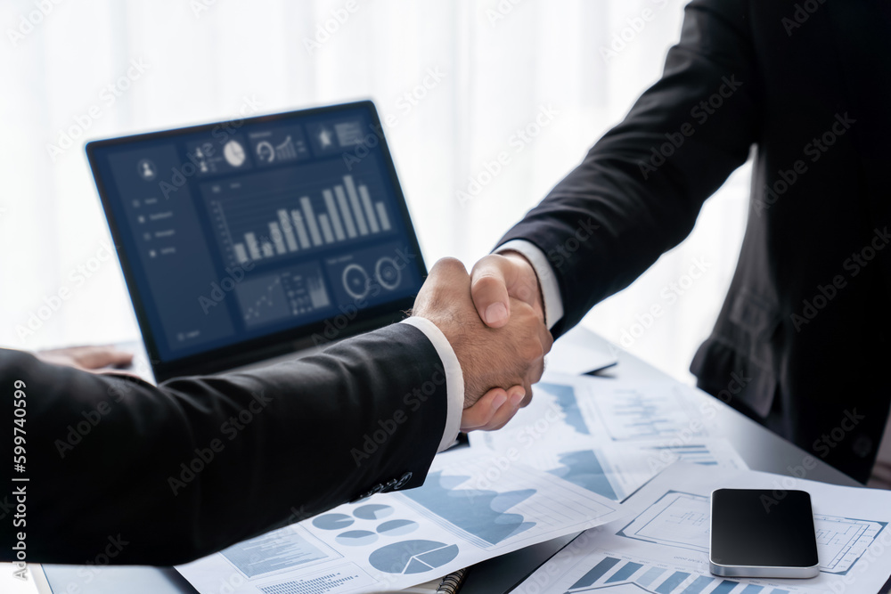 Closeup professional businessman shaking hands over desk in modern ...