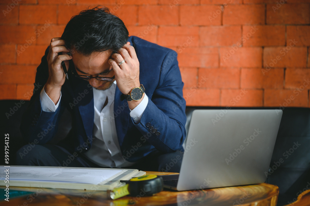 male business man sitting disappointed sad at work wooden desk in the ...