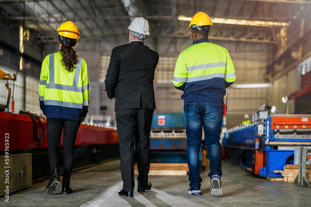 Senior boss manager inspecting with staff engineers woman and African ...