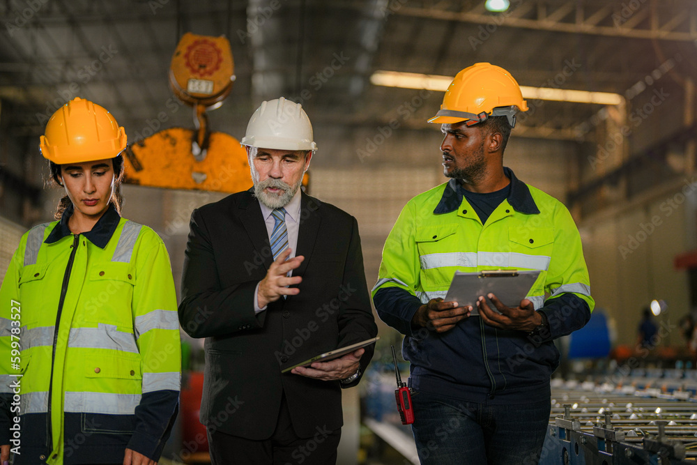 team of engineers checking control heavy machine in factory. Senior ...