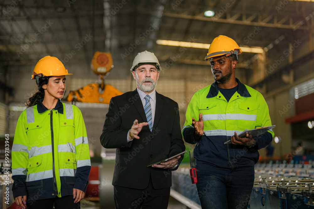 team of engineers checking control heavy machine in factory. Senior ...