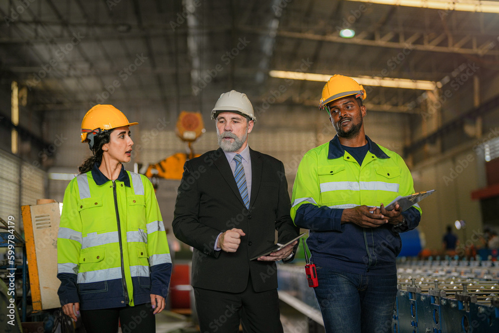 team of engineers checking control heavy machine in factory. Senior ...