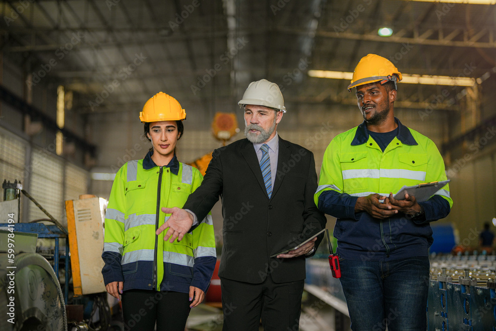 team of engineers checking control heavy machine in factory. Senior ...