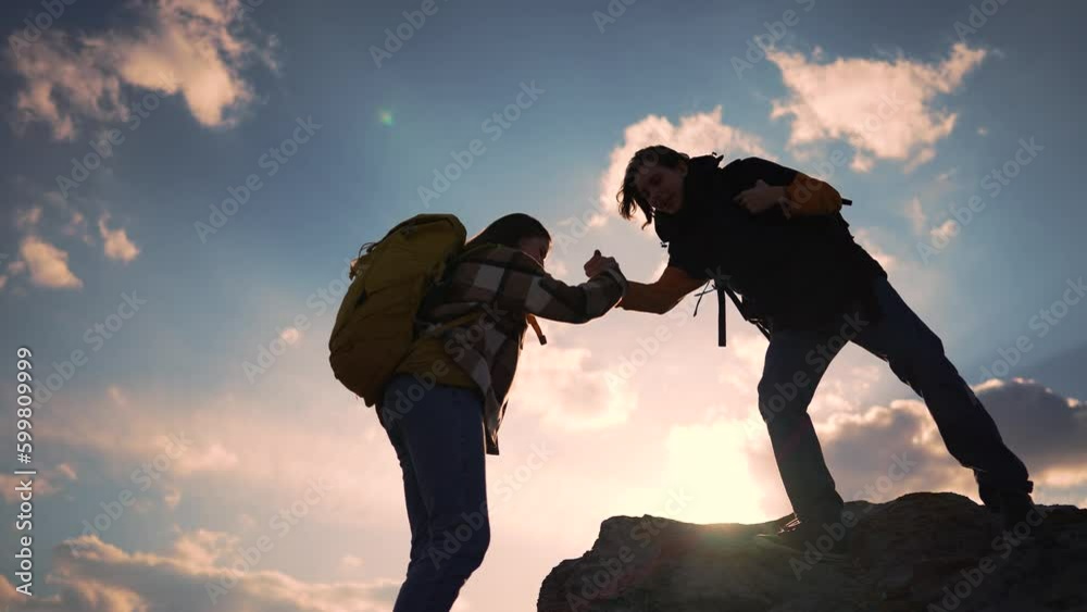 Climbers team up to conquer the mountain.Helping hand in teamwork is ...