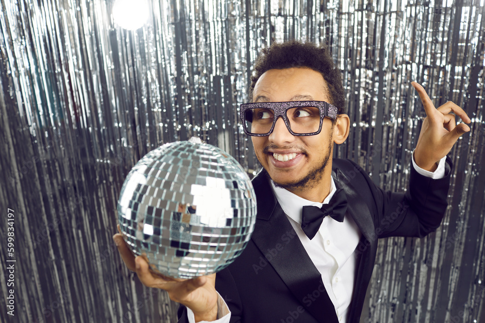 Lets get party. Cheerful young dark-skinned disco man in suit with ...