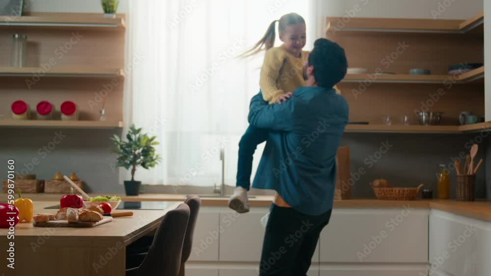 Happy family at kitchen blurry view little daughter run to dad child ...