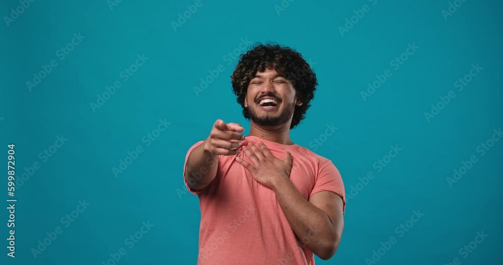 Young indian man pointing finger to camera, laughing out loud, taunting ...