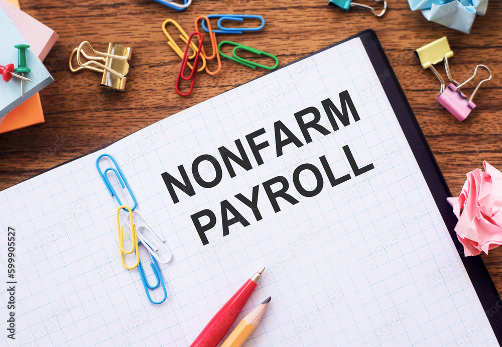 NON FARM PAYROLL text written on a wooden background with keyboard ...