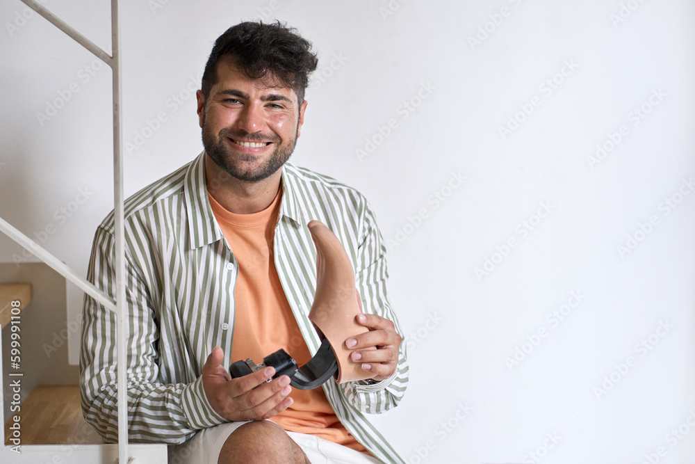 Happy man amputee with disability or amputation holding artificial foot ...