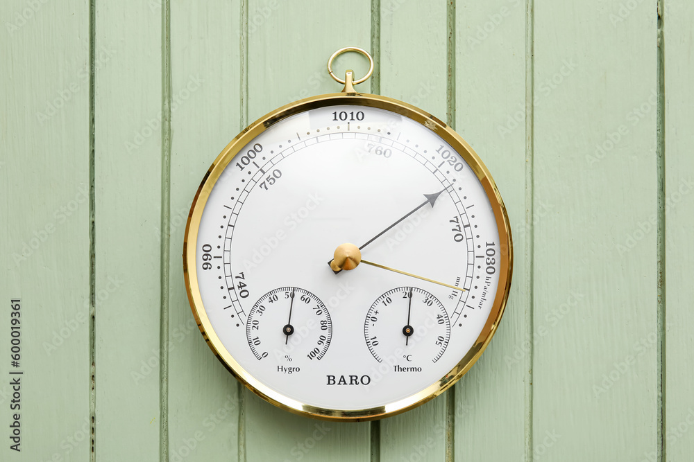 Aneroid barometer on green wooden background Stock Photo | Adobe Stock