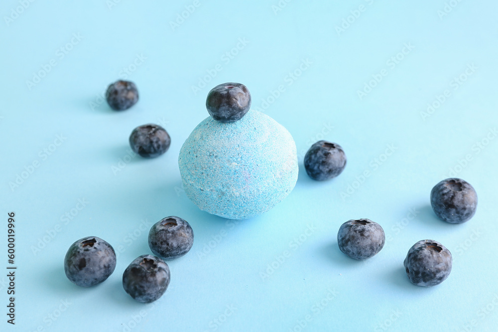 Bath bomb with blueberry on blue background Stock Photo | Adobe Stock