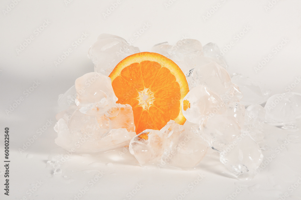 Sliced fresh orange and ice cubes on white background Stock Photo ...