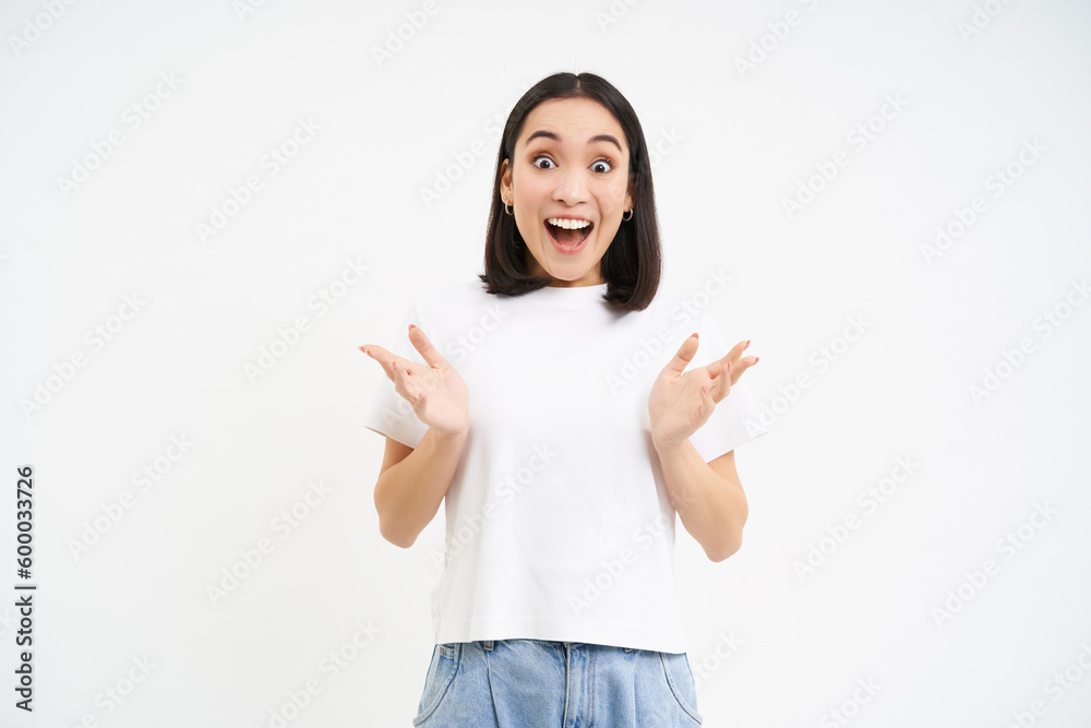 Enthusiastic asian woma, clap hands and smiles with surprised, happy ...