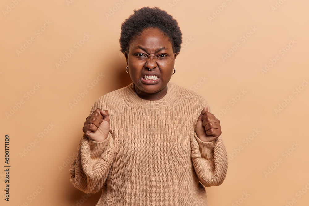Displeased outraged Afro American woman has furious facial expression ...
