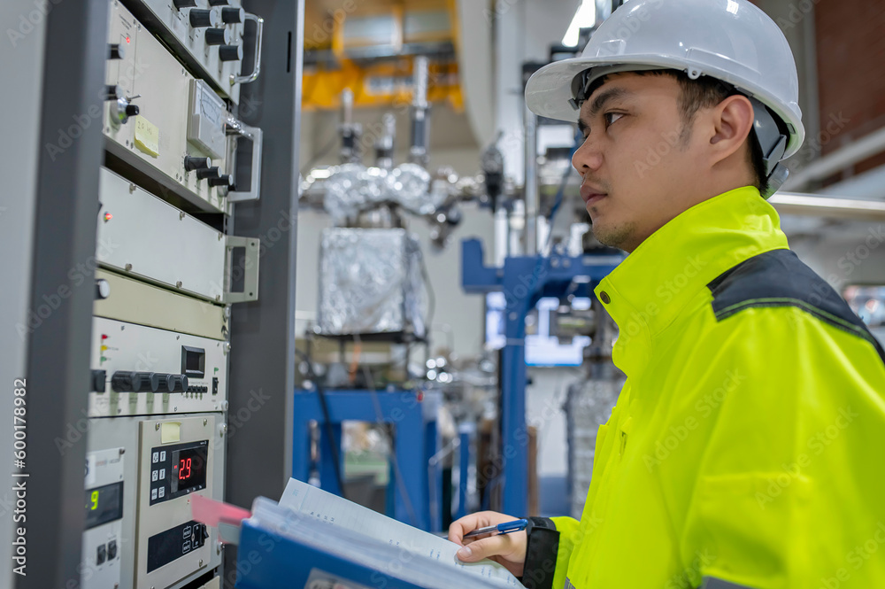 Electrical engineer woman checking voltage at the Power Distribution ...