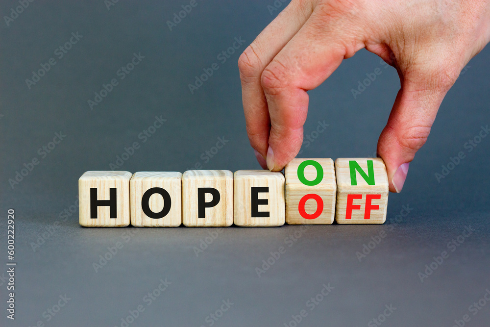 Hope on or off symbol. Businessman turns wooden cubes and changes word ...