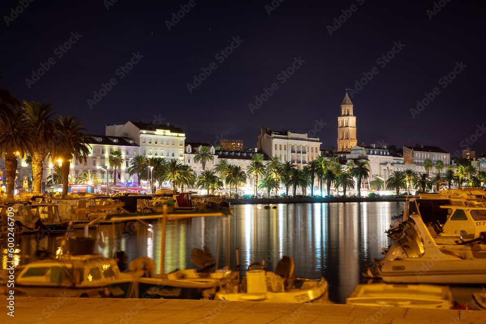 Riva boardwalk in Split, Croatia at night. Reflections of colorful city ...