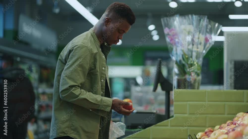 Black Man shopping in produce section of supermarket. Grocery Shopping ...
