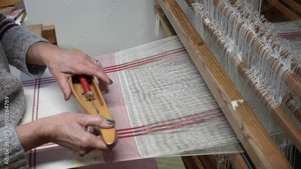 Textile industry, Woman hand working with weaving loom at textile ...