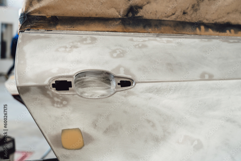 The car body after the accident is covered with putty, primer before ...