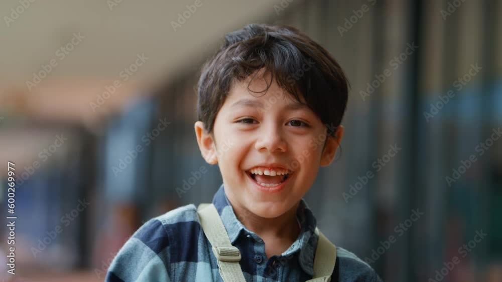 Head and shoulders portrait of smiling male elementary school student ...
