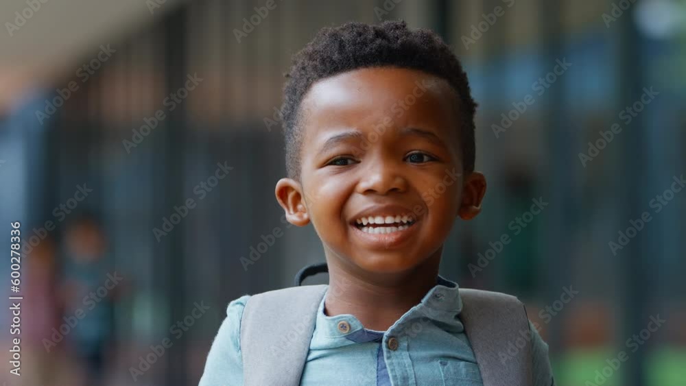 Head and shoulders portrait of smiling male elementary school student ...