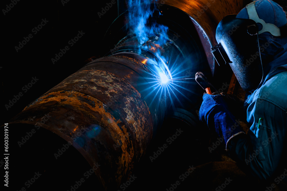 Industrial welder welding fabricated construction in factory, Welding ...
