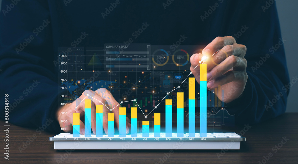 Businessman using tablet analyze sales data and economic growth graph ...