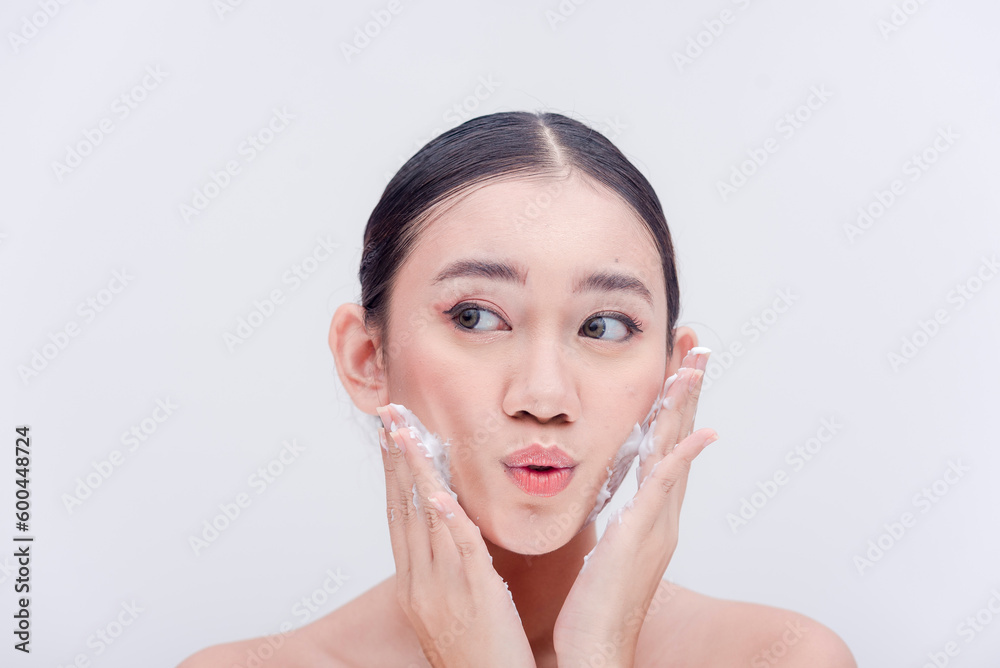 Female commercial model applying facial wash for her skin care routine ...