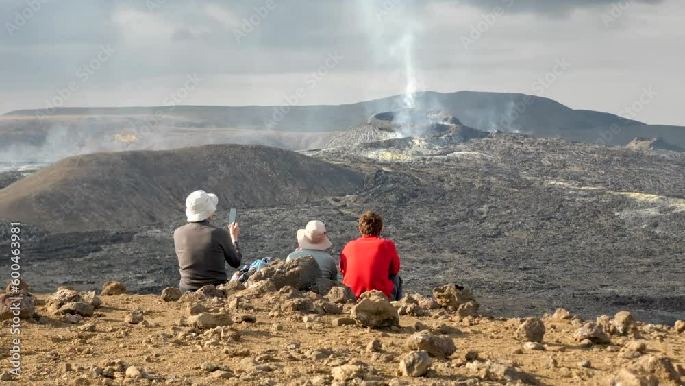 Family wachting Fagradalsfjall active volcano eruption in Geldingadalir ...