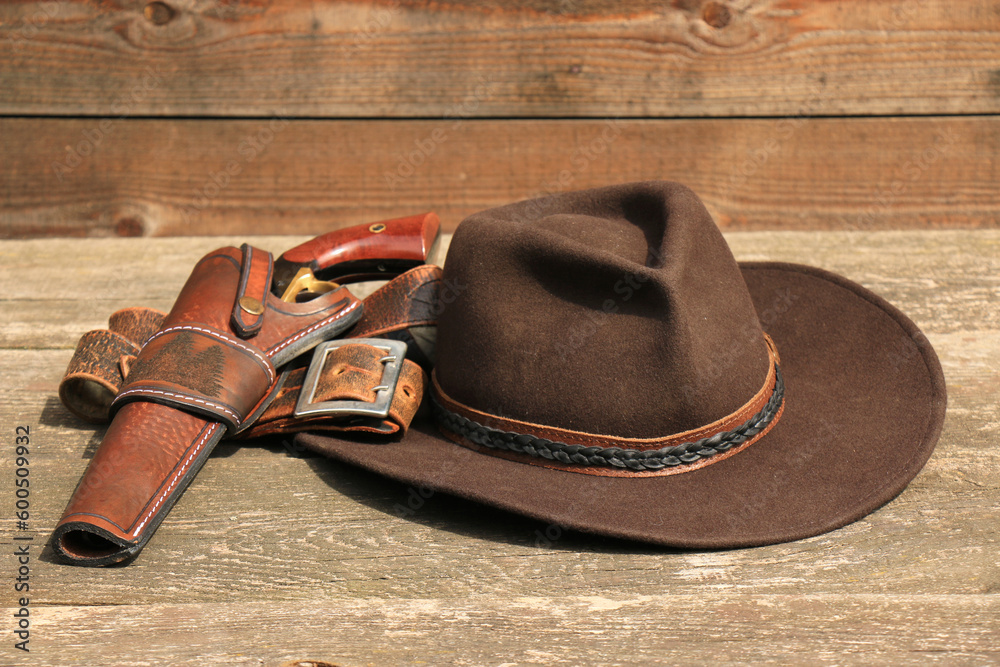 A black powder revolver in a leather holster with a leather belt next ...