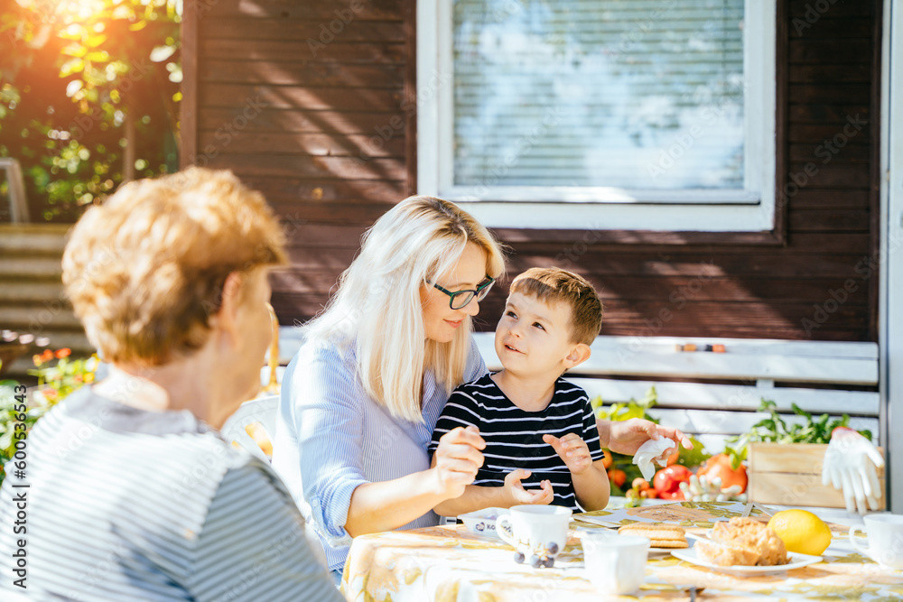 Family eating outdoors. Garden summer fun. Barbecue in sunny backyard ...