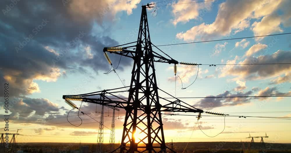 High-voltage electric pole support at sunset, aerial shot. Electrical ...